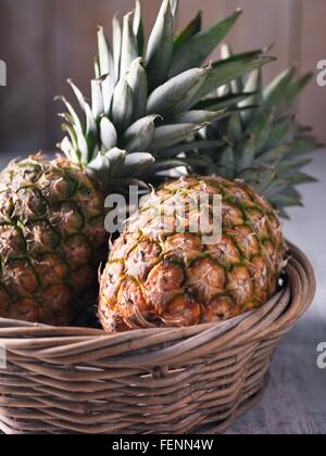 pineapple in wicker basket Stock Photo - Alamy