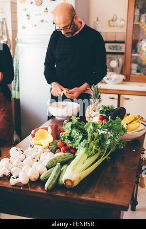 Artichokes on kitchen table Stock Photo - Alamy