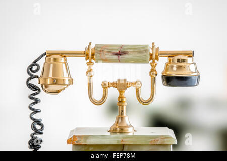 Golden telephone in retro style on white background Stock Photo - Alamy