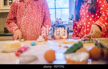 Boy peeking over kitchen counter Stock Photo - Alamy