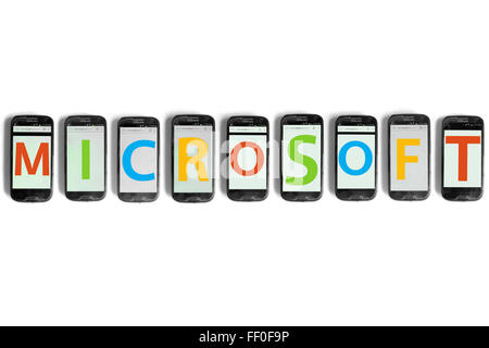 Microsoft written on the screens of smartphones photographed against a ...