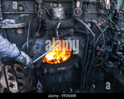 Stoking a fire of a steam locomotive Stock Photo - Alamy