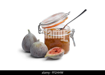 Fig jam in glass jar and fresh figs on white wooden background, top ...