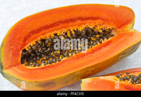 Cross section of a cut papaya with the fruit and the seeds. The Papaya ...