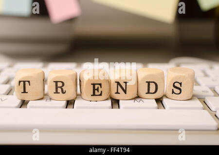 Wooden dices on a keyboard with the word trends Stock Photo - Alamy