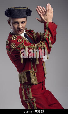 Studio shot of man dressed as Spanish torero, matador, bullfighter ...