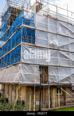 Scaffold with plastic sheet covering erected on a building Stock Photo ...
