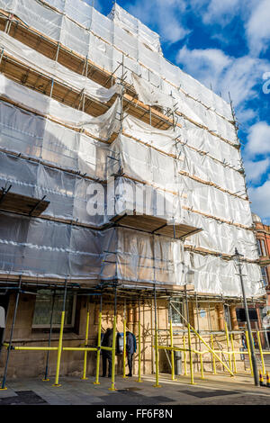 Scaffold with plastic sheet covering erected on a building Stock Photo ...