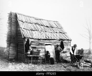 African American farm family outside their log cabin home in North ...