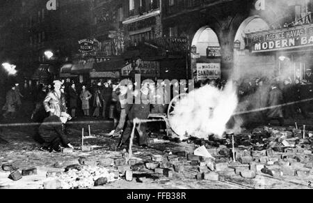FRANCE: PARIS RIOTS, 1934. /nA rioter hurling a missle from behind ...