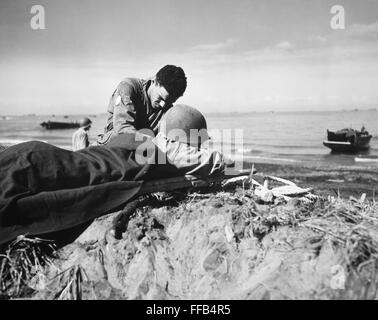 WORLD WAR II: MEDIC, 1942. /nA survivor of the U.S.S. Calhoun receiving ...