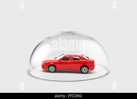 Red car protected under a glass dome Stock Photo - Alamy
