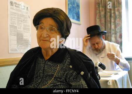 Elderly residents having discussions over lunch in Schonfeld square ...