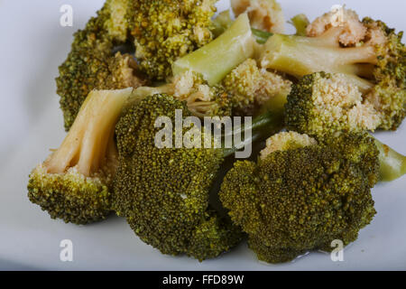Green boiled caulliflower in the white plate Stock Photo - Alamy