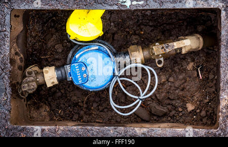 Water meter in the ground Stock Photo - Alamy