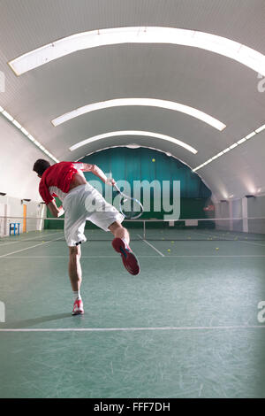 Young tennis player kicking the ball at the training Stock Photo - Alamy
