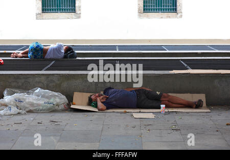 Rio de Janeiro, Brazil. Homeless street child crouching in the gutter ...