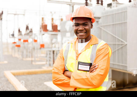 African electrical engineer with arms crossed in electricity power ...