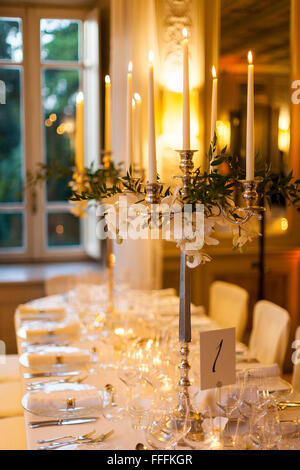 Table setting with candles at gala dinner Stock Photo - Alamy