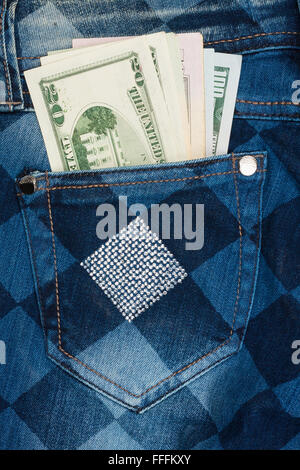 Money sticks out of the pocket of his jeans with rhinestones, as ...