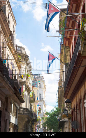 Havana, Cuba, two Cuban flags hanging in the balcony of a weathered ...