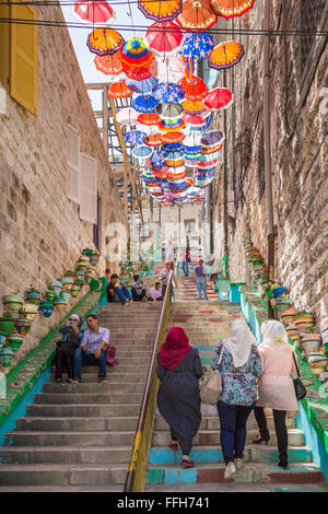 Stairs in old Amman decorated with colorful umbrellas and flower pots ...