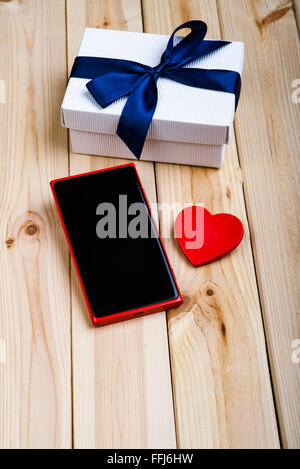 Little gift box with heart ribbon, copy space, background and greeting ...