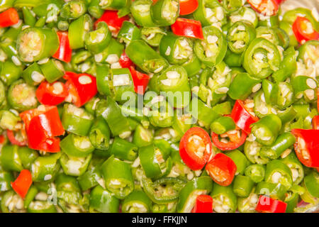 Fresh red chilli, and green chilli, finely chopped, mix together on a ...