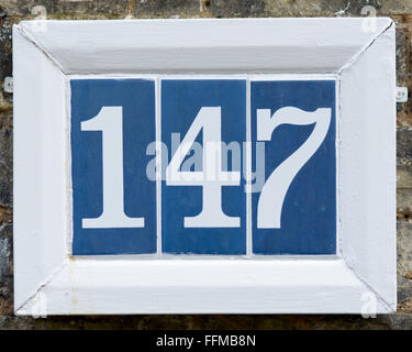 House Number 147 painted sign on wall Stock Photo - Alamy