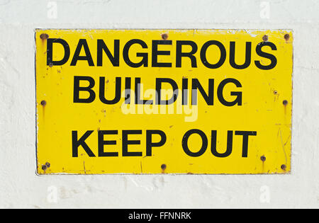 Sign warning of a dangerous building and to keep out. The building has ...