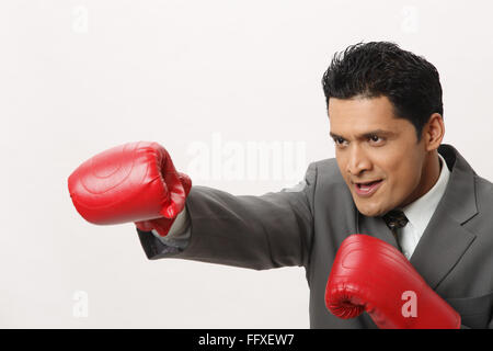 Young businessman employee wearing boxing gloves at workplace Stock ...