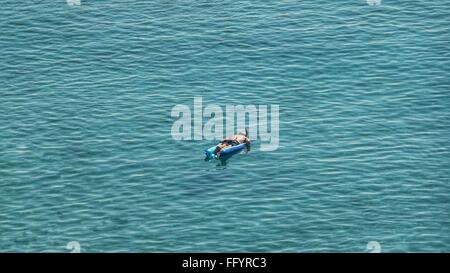 Man on a lilo Stock Photo: 1204190 - Alamy