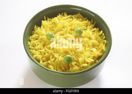 Indian cuisine khichdi garnish green peas served in deep plate on white ...