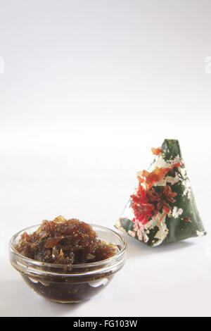 Gulkand and gilouri pan folded in betel leaves on white background ...