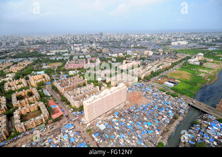 Aerial view of Government Colony and slums ; rich poor ; old new ; then ...