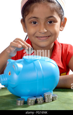 Blue old piggy bank with coins on a wooden table Stock Photo - Alamy