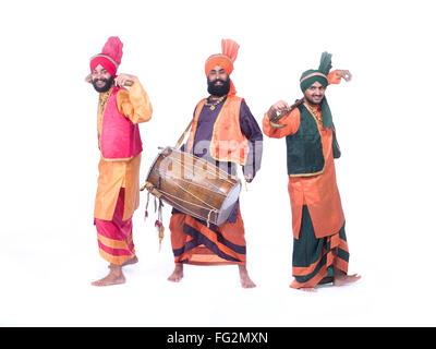 Dancer playing musical instrument dholak in folk dance bhangra MR#779C ...