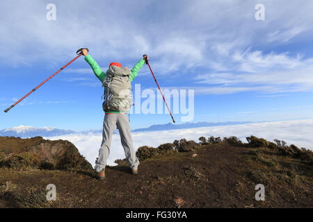 cheering young woman hiker open arms on mountain peak Stock Photo - Alamy