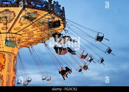 fairground funfair ride moving fast fair lights Night colours of the ...