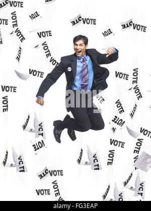 Young voter man smiling happy putting vote in voting box at electoral ...