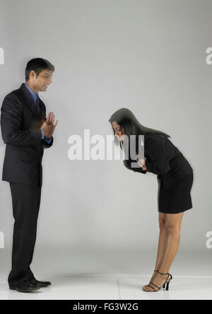 Man and woman bowing Stock Photo - Alamy