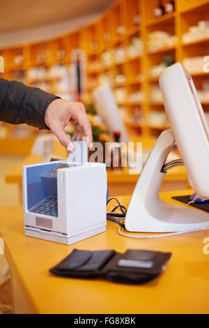 Man putting credit card into wallet in bedroom, closeup Stock Photo - Alamy