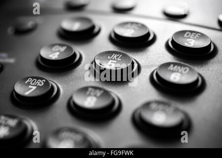 Modern black business landline telephone with number keypad close-up ...