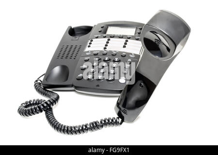 Picture of a business landline telephone with the receiver off the hook ...