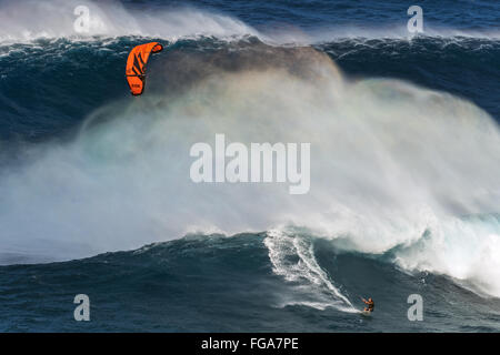 MAUI, HAWAII, USA - DECEMBER 15, 2013: Unknown surfer is riding a big ...