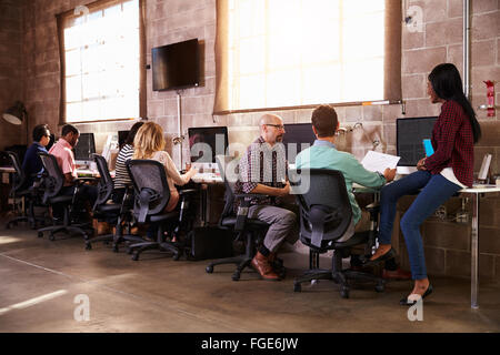 Row of people working at desks in office Stock Photo: 72491243 - Alamy
