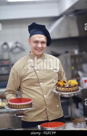 Young male cook working in the kitchen Stock Photo - Alamy