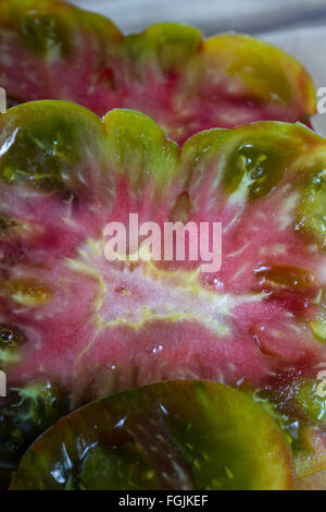 beautiful flavorful tomato cut in half with a colorful pattern and ...