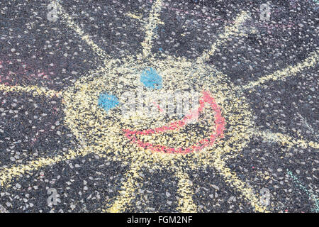 Kids drawing sun with chalk Stock Photo - Alamy