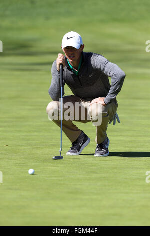 Rory McIlroy of Northern Ireland lines up a putt on the 17th green ...